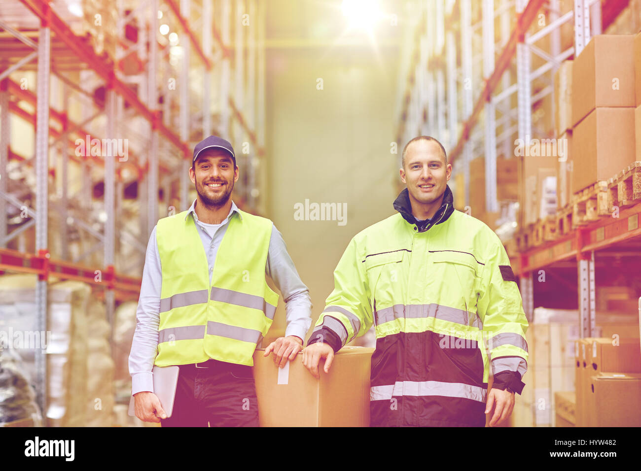 men in uniform with boxes at warehouse Stock Photo - Alamy