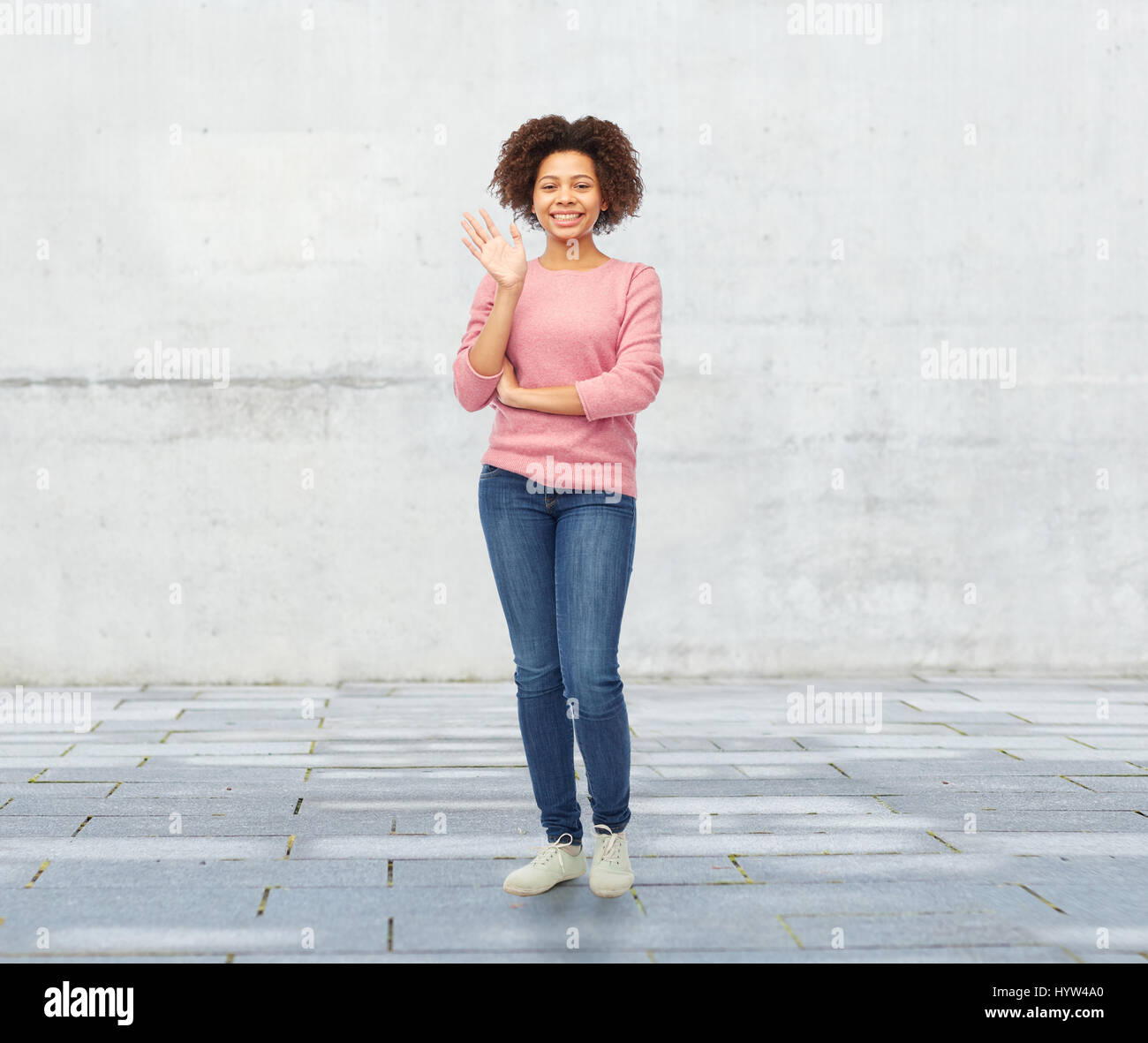 happy african american young woman waving hand Stock Photo - Alamy
