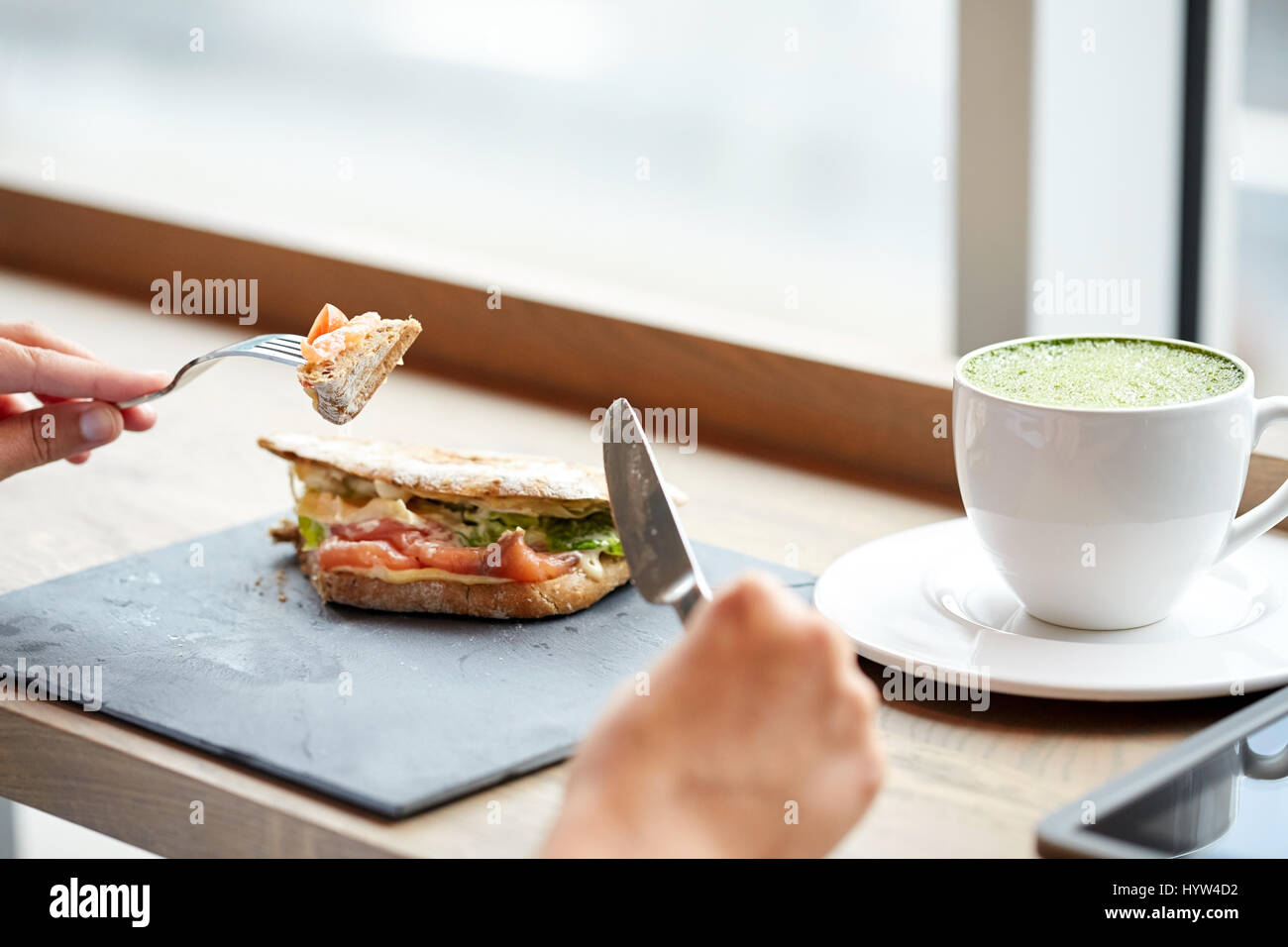 woman eating salmon panini sandwich at restaurant Stock Photo - Alamy