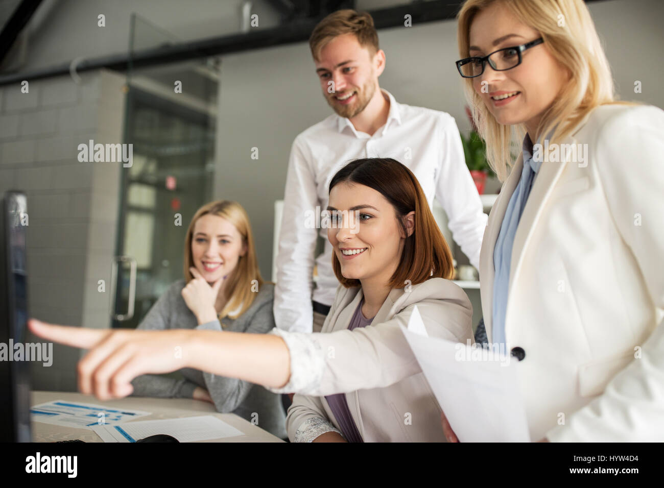 Happy business team looking computer hi-res stock photography and ...