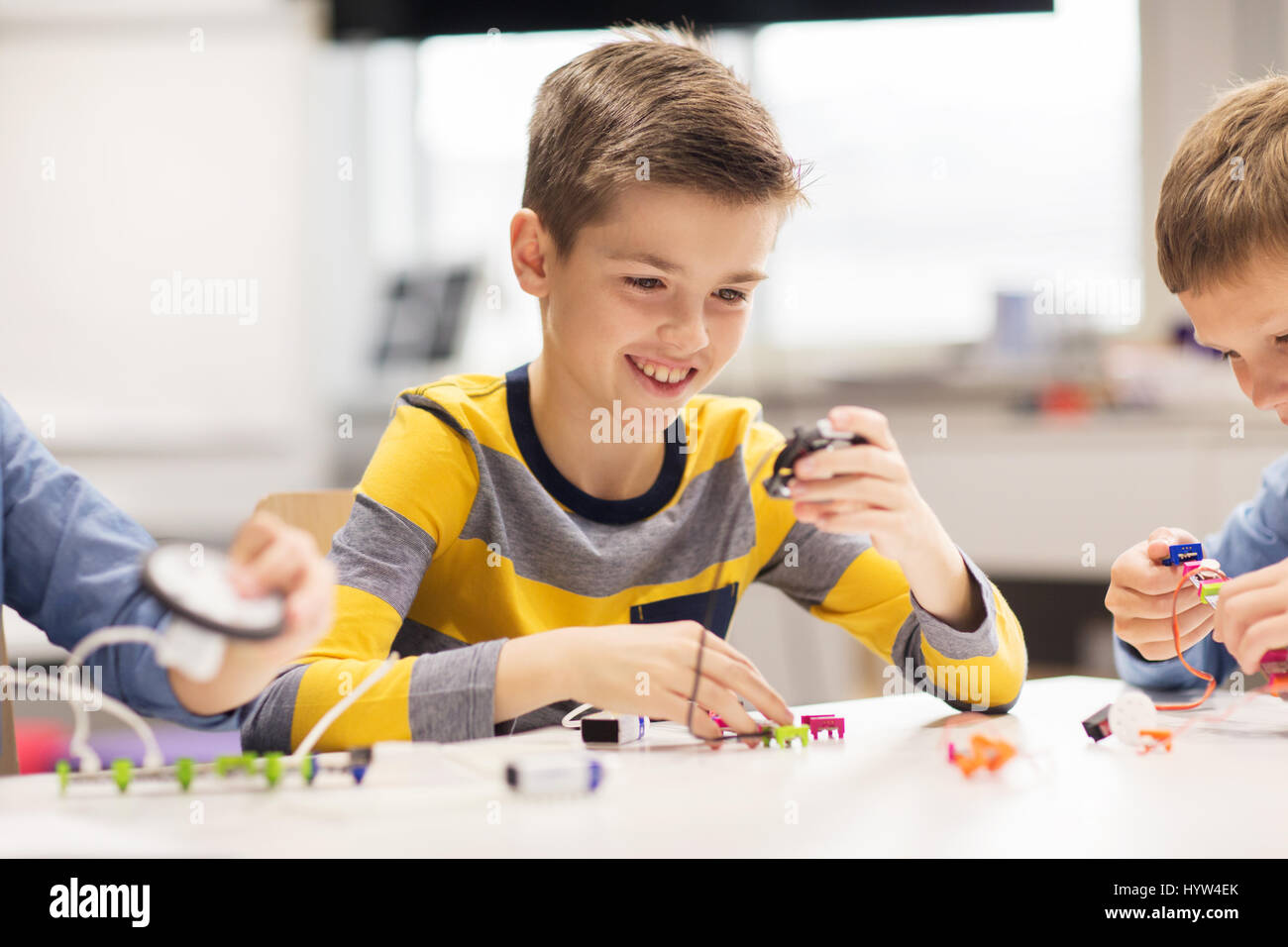 happy boy building robot at robotics school Stock Photo - Alamy