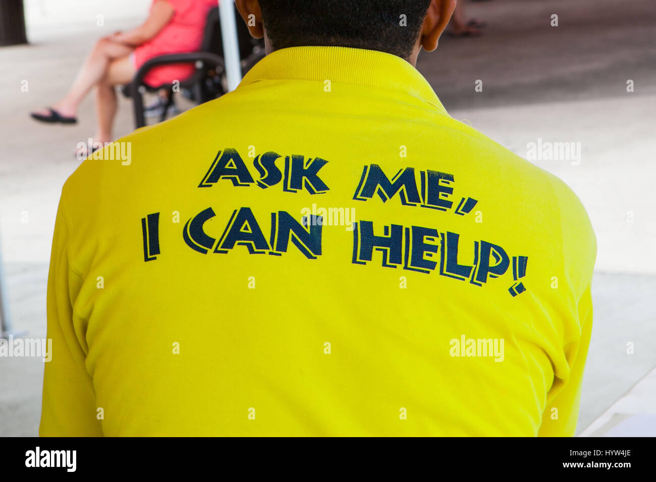 Tourist information employee wearing an "ask me, I can help" logo on ...