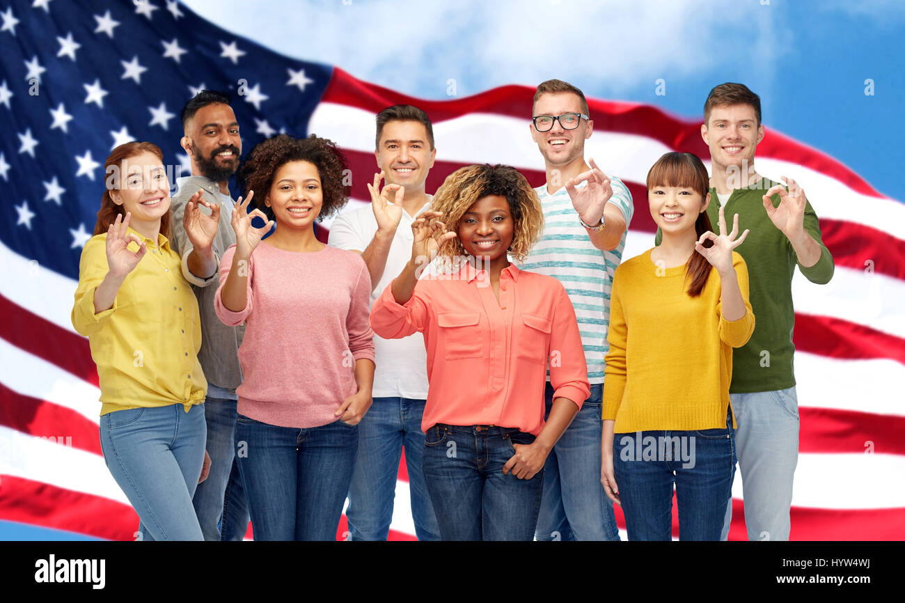 international people showing ok over american flag Stock Photo - Alamy
