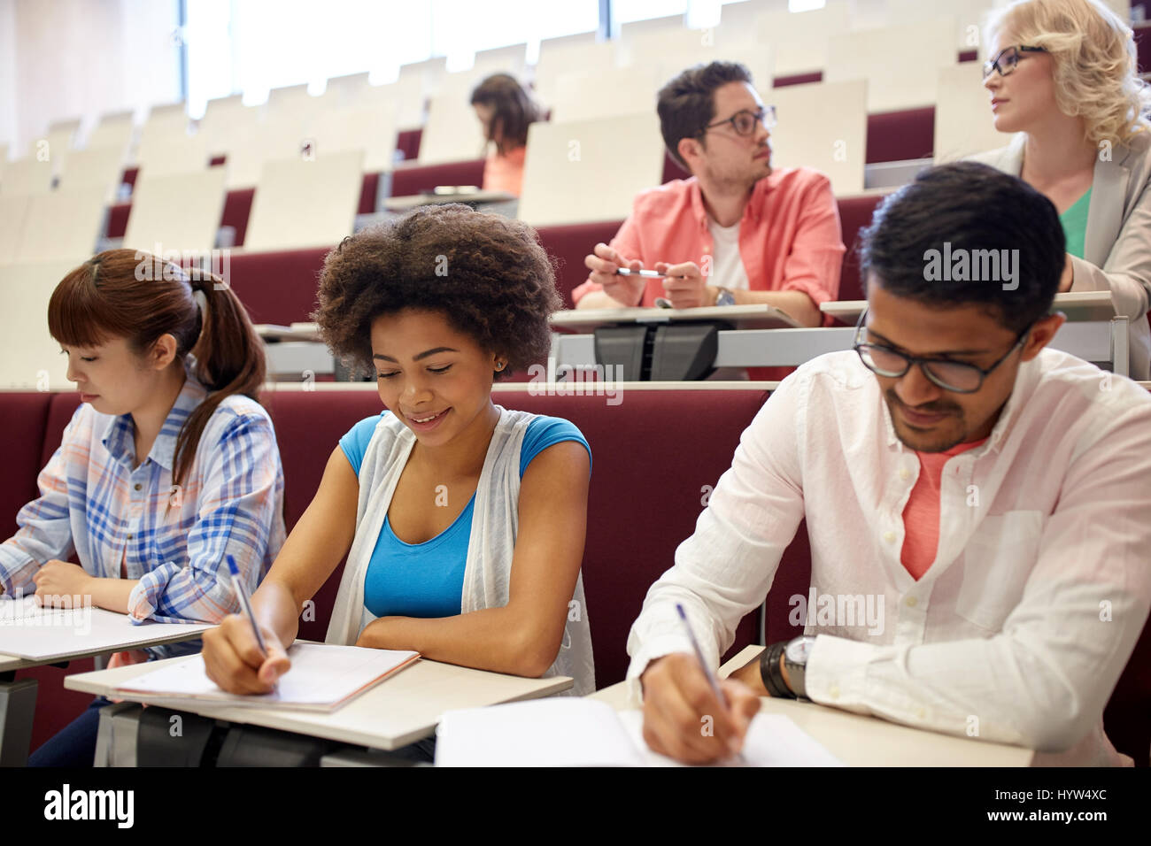 group of students with notebooks in lecture hall Stock Photo - Alamy