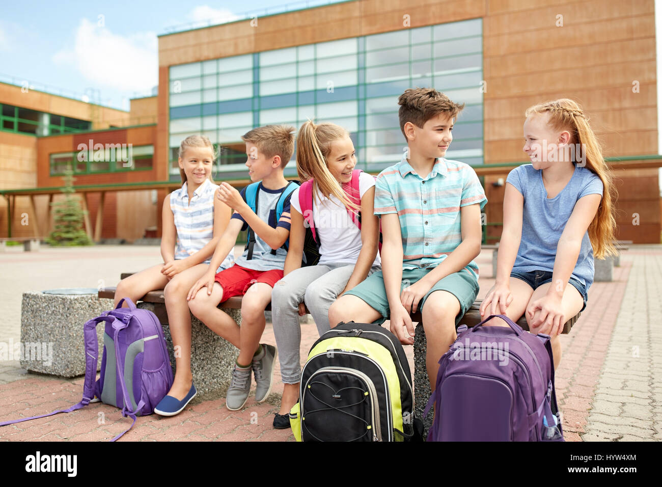 group of happy elementary school students talking Stock Photo - Alamy