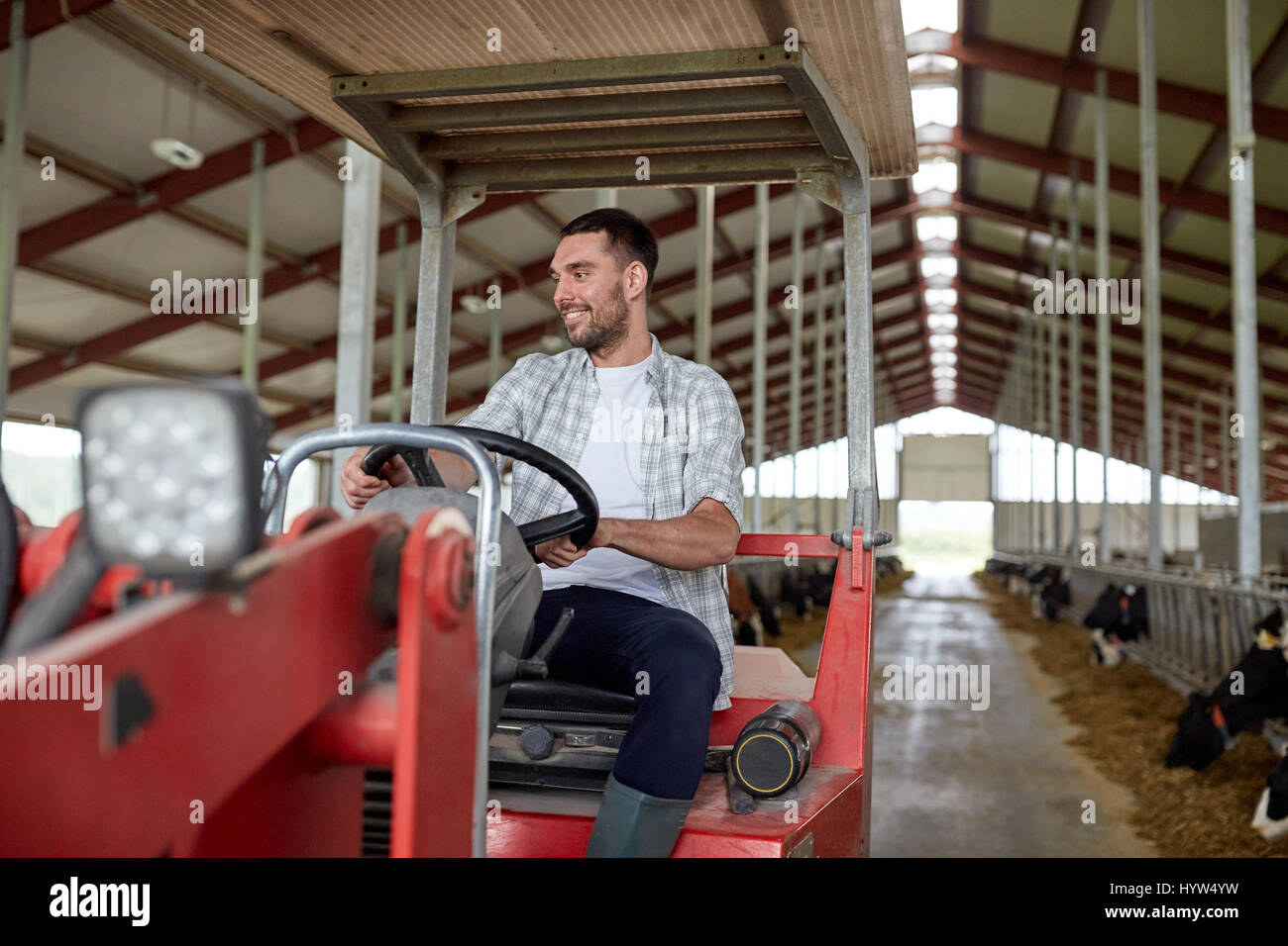 man or farmer driving tractor at farm Stock Photo - Alamy
