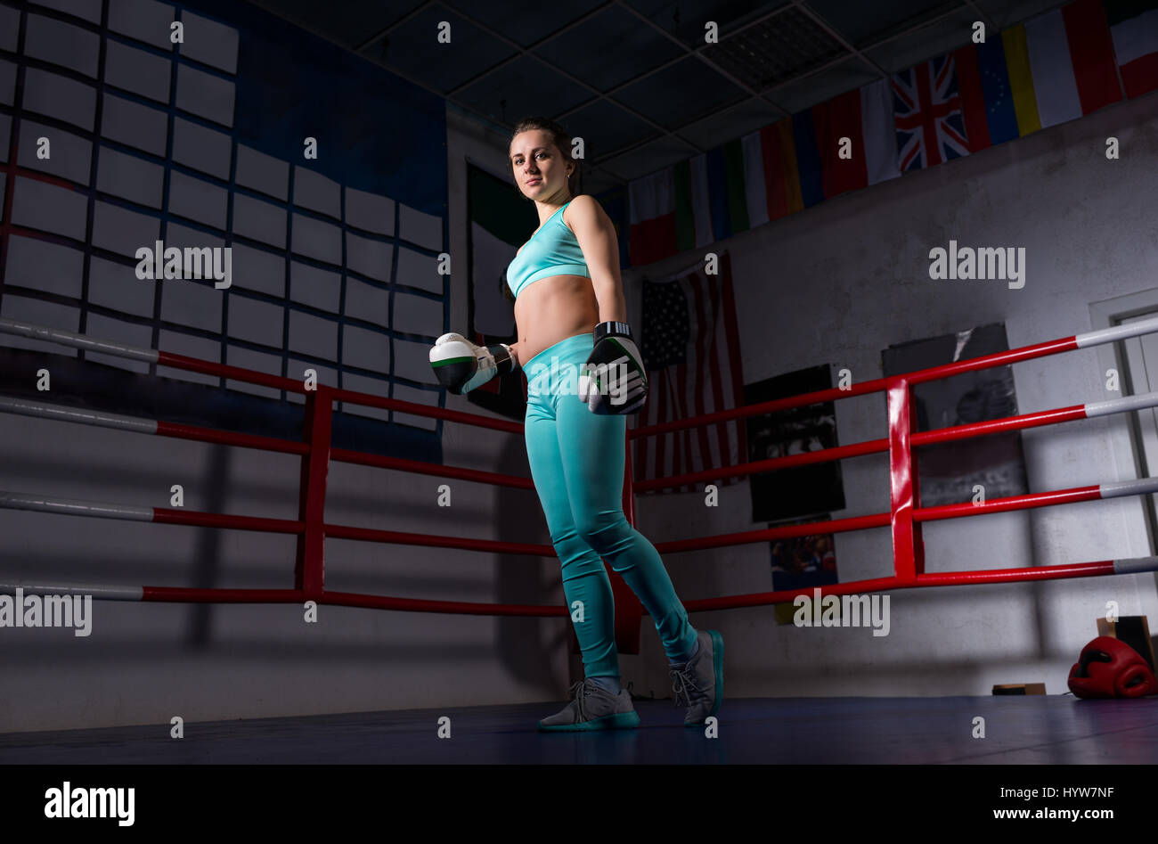 Young female boxer with boxing gloves training and prepares for battle ...