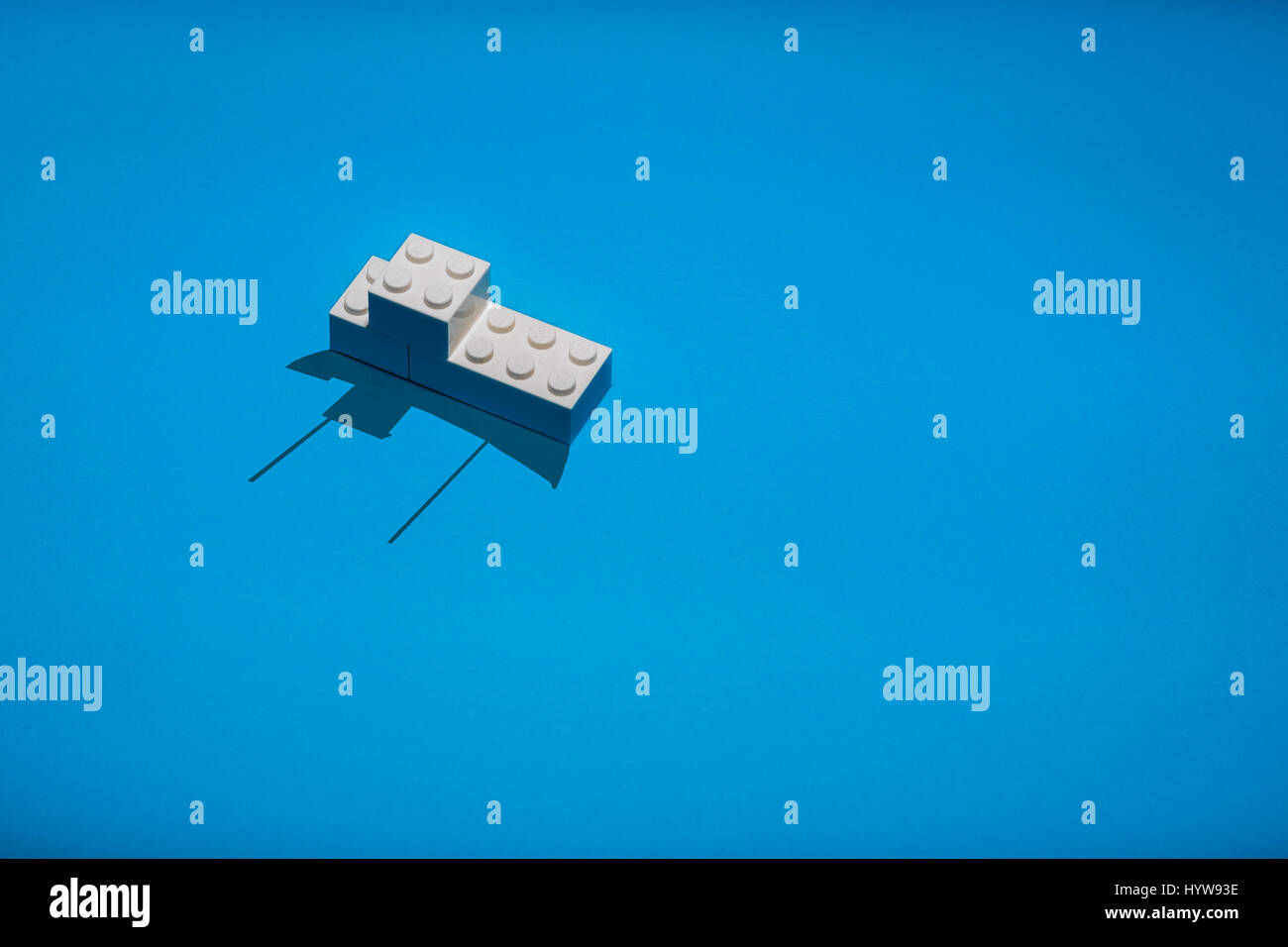 this photo is a white lego cube in boat's form that means three cubes ...