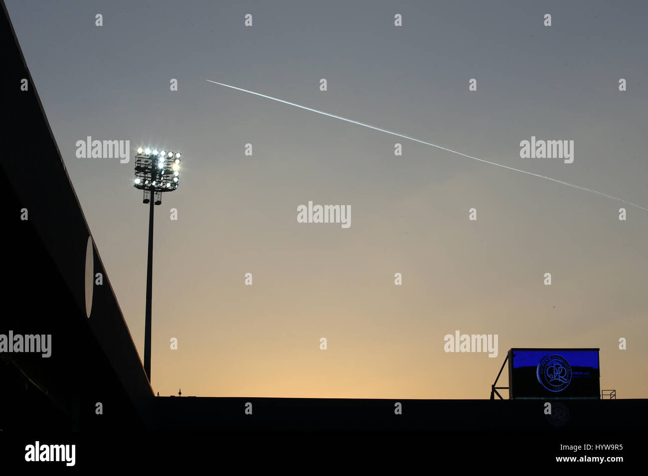 A plane flies over Loftus Road as the sun sets during the Sky Bet ...
