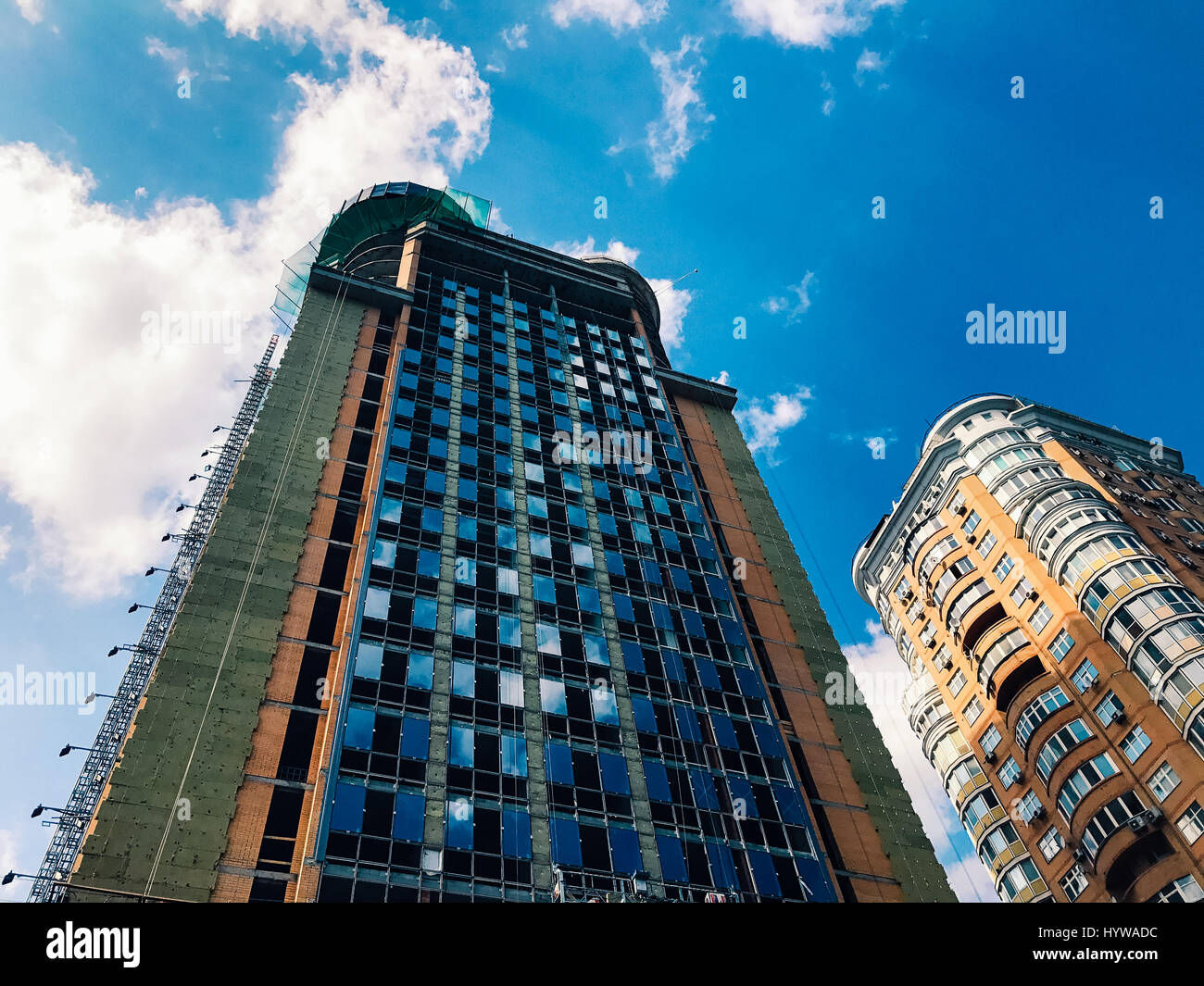 Top part of high-rise business building on blue sky Stock Photo - Alamy