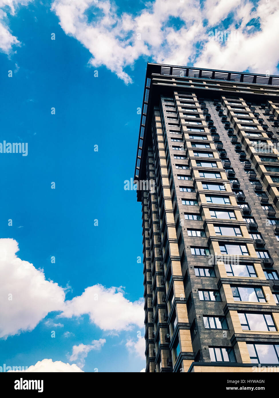 Top part of high-rise business building on blue sky Stock Photo - Alamy