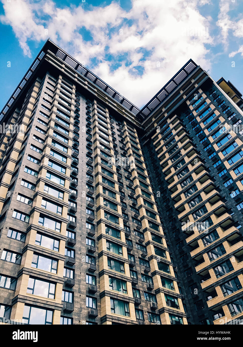 Top part of high-rise business building on blue sky Stock Photo - Alamy
