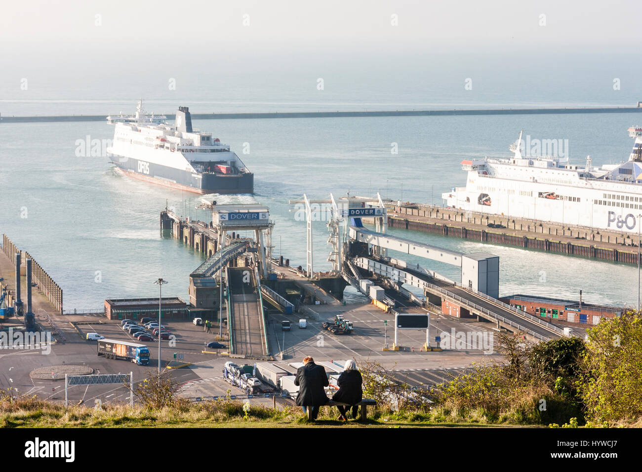 England, Dover. Foreground is Edlerly couple sitting on bench on ...