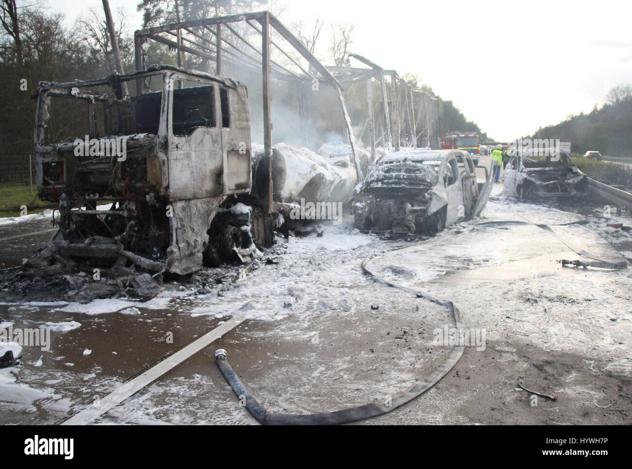 A burned trailer truck and cars standing on the Autobahn A2 between ...