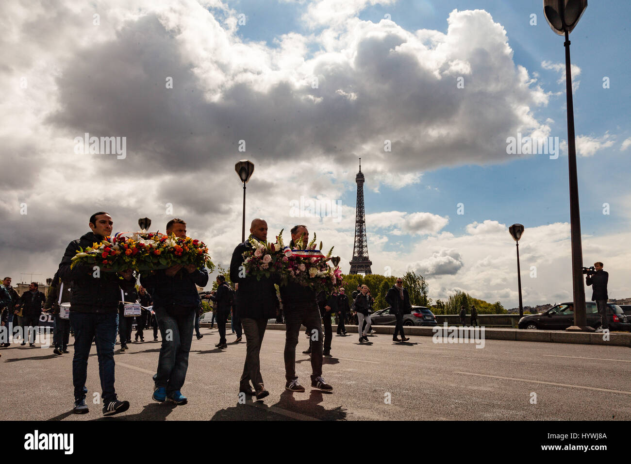 Paris, France. 26th April, 2017. Police officers hold funeral flowers ...