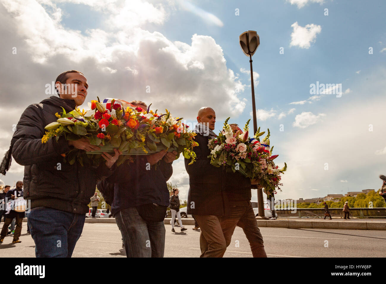 Paris, France. 26th April, 2017. Police officers hold funeral flowers ...