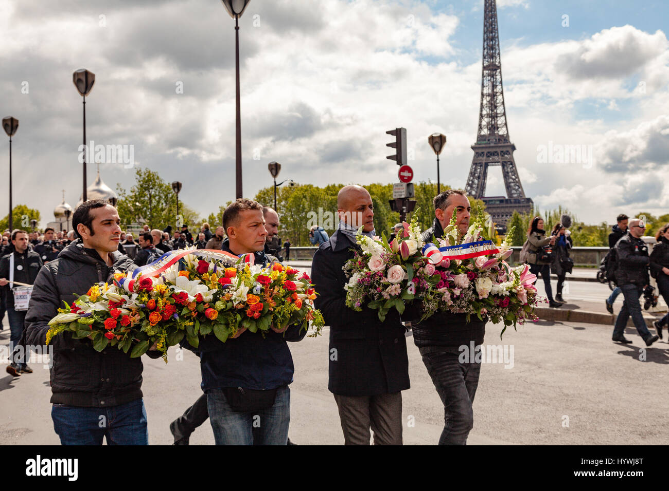 Paris, France. 26th April, 2017. Police officers hold funeral flowers ...