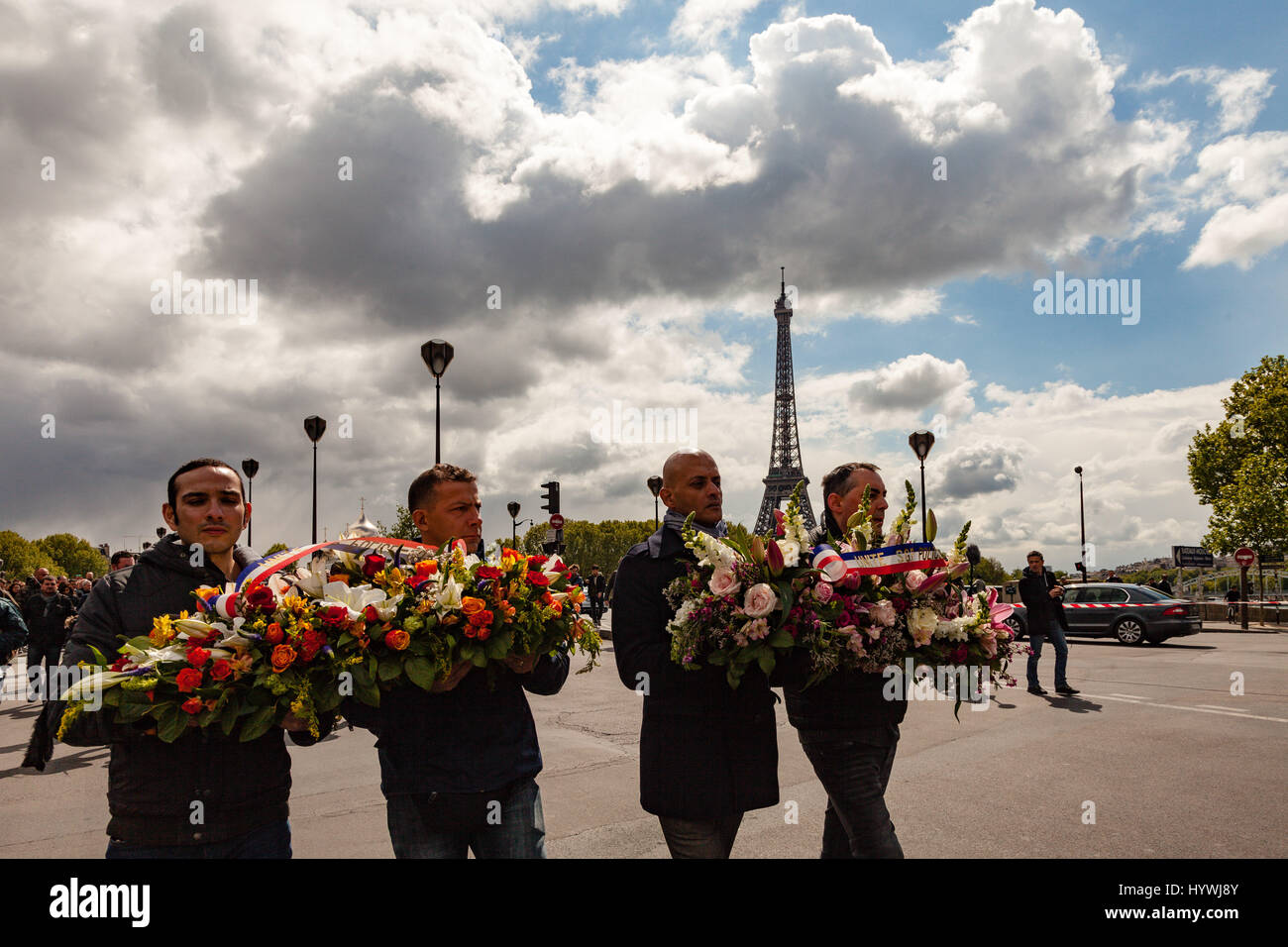 Paris, France. 26th April, 2017. Police officers hold funeral flowers ...