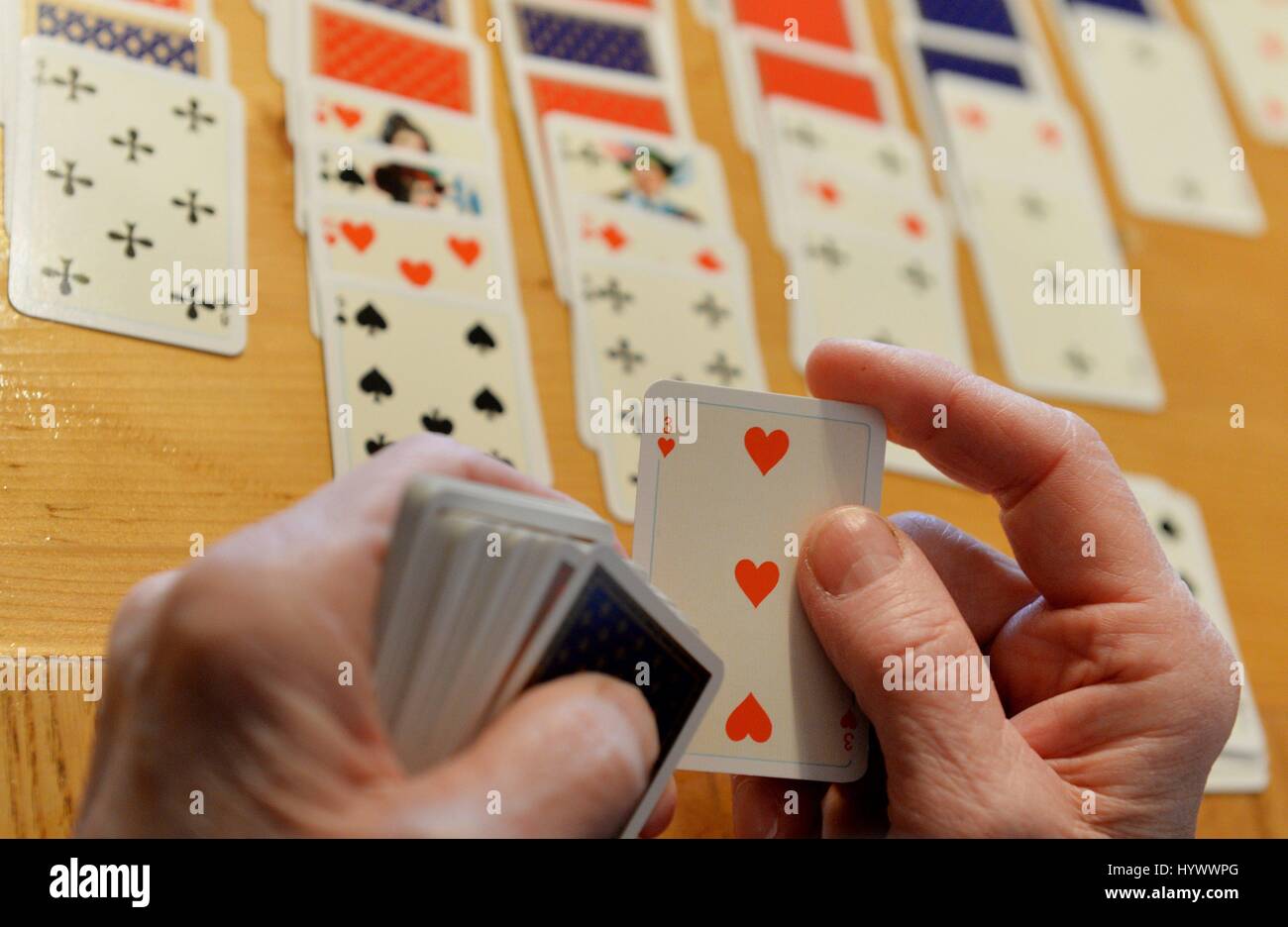 Woman playing solitaire card game hi-res stock photography and images ...