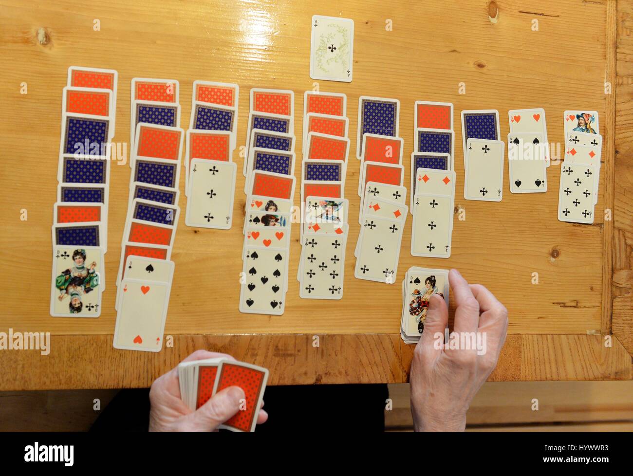 Woman playing solitaire card game hi-res stock photography and images ...