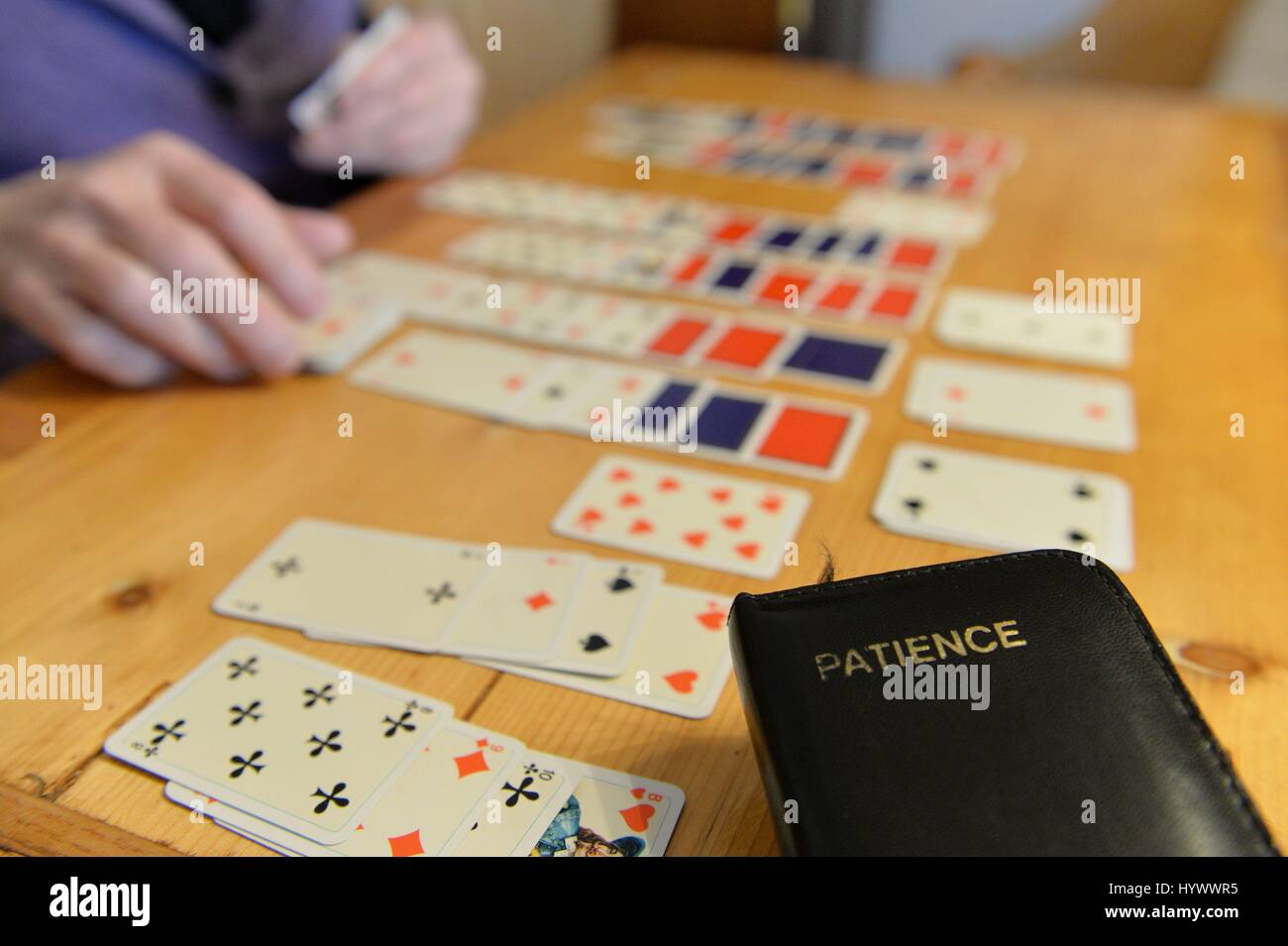 Woman playing solitaire card game hi-res stock photography and images ...