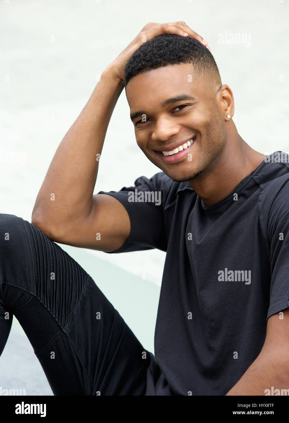 Close up portrait of a happy black man smiling against white background ...