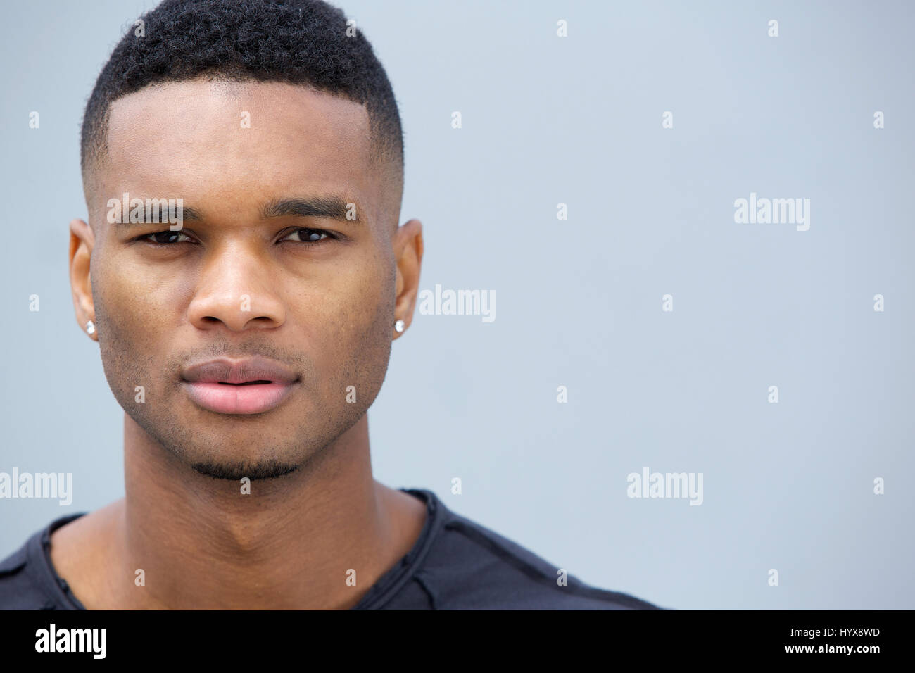 Close up portrait of a handsome male fashion model looking at camera ...