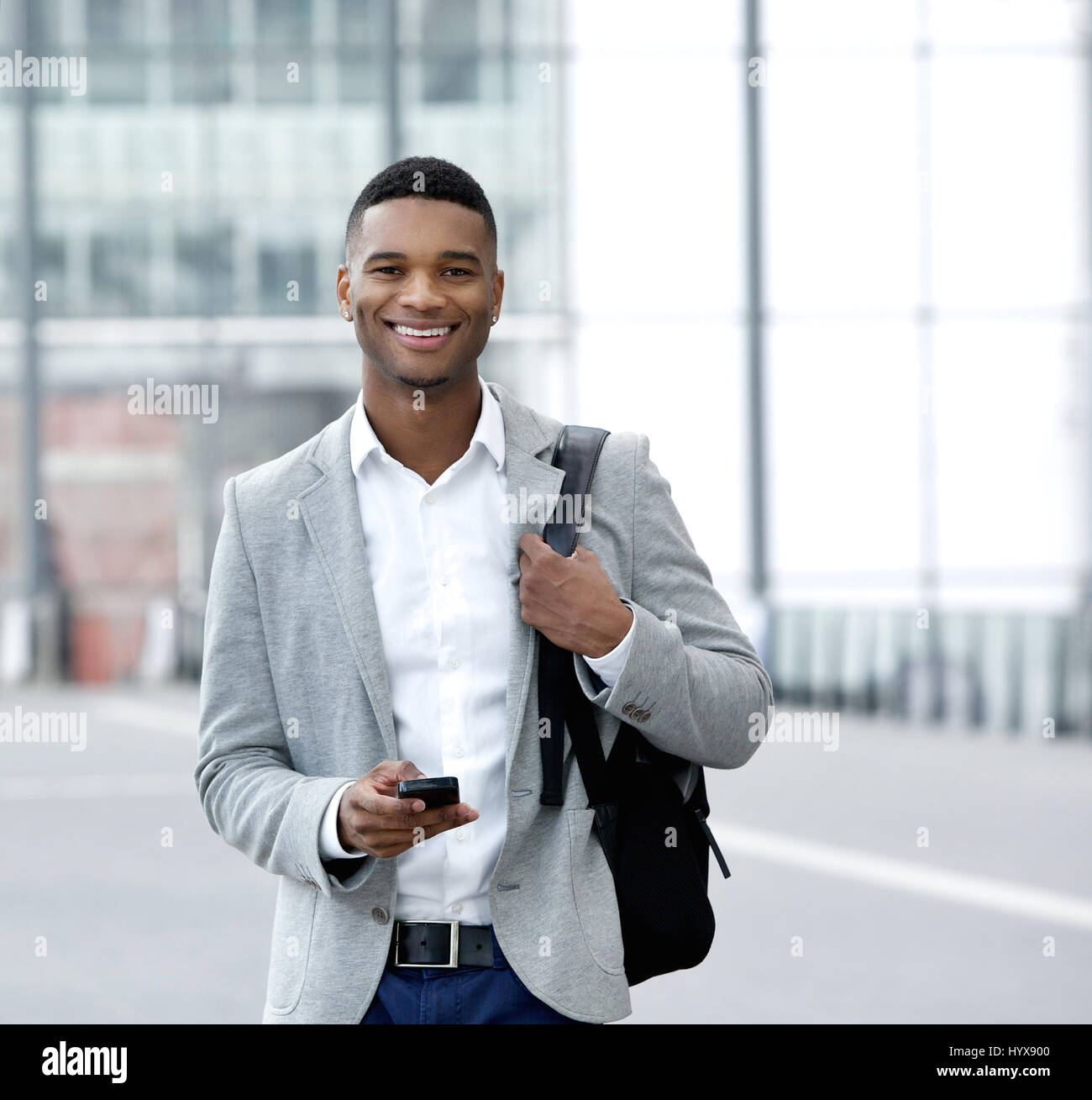 Portrait of a handsome young man text messaging on mobile phone Stock ...