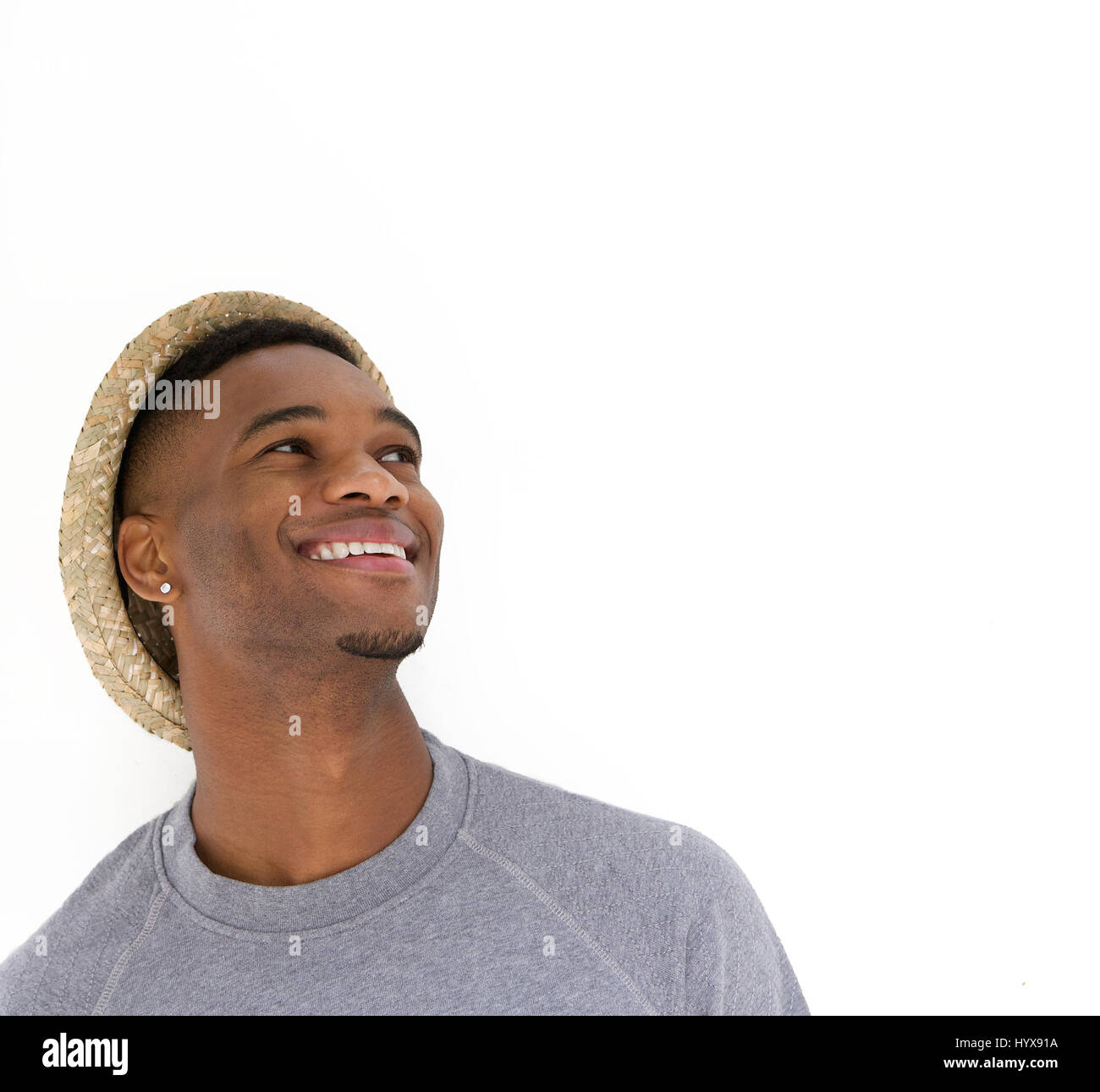 Close up portrait of a cool guy laughing with hat on white background ...