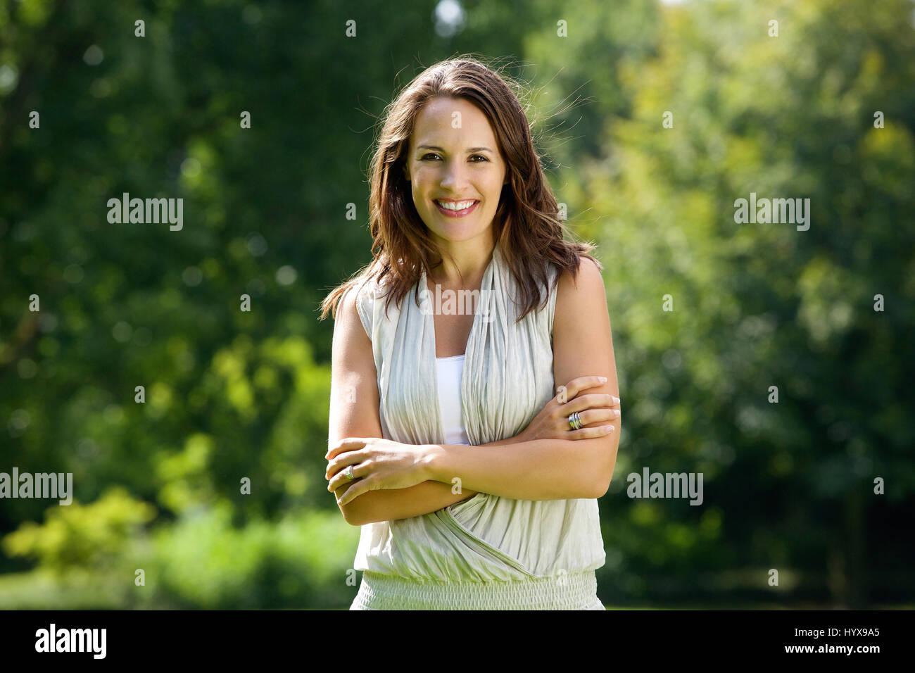 Confident girl standing arms crossed hi-res stock photography and ...