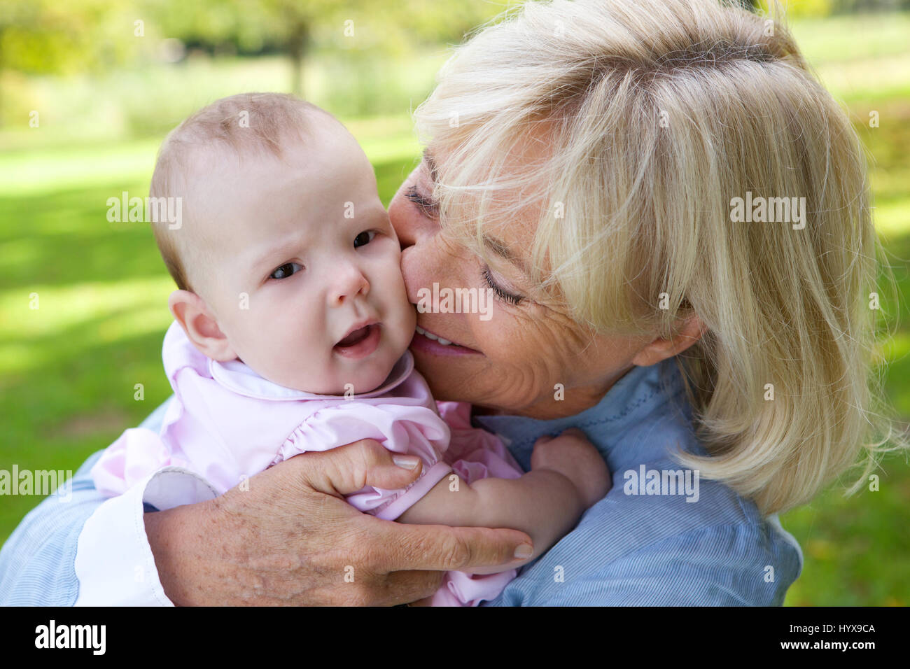 Grandmother hugging grandchild hi-res stock photography and images - Alamy