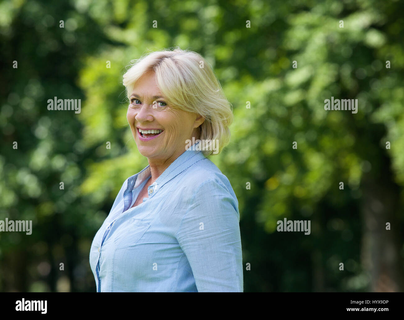 Close up portrait of a cheerful older woman smiling outdoors Stock Photo - Alamy