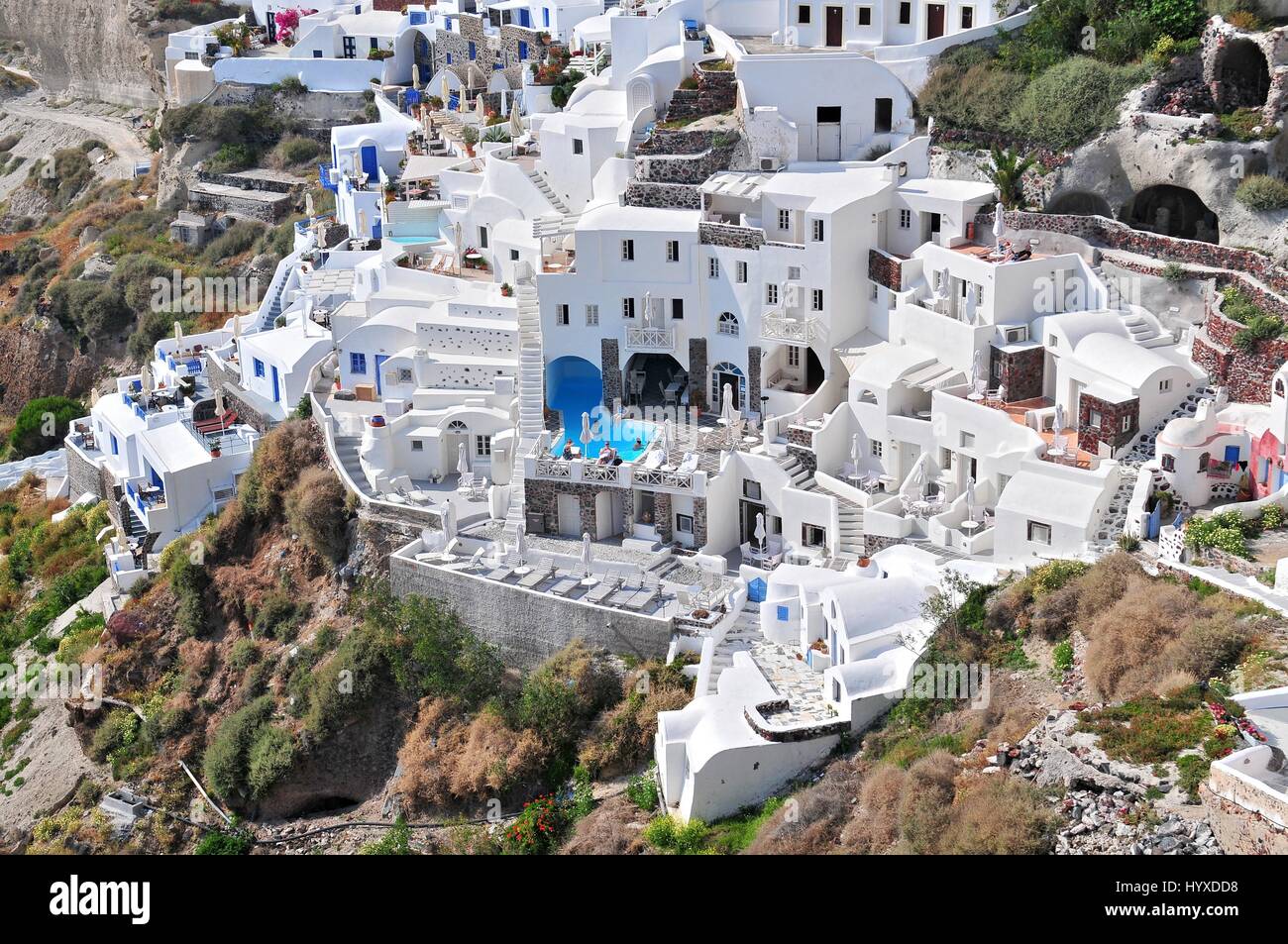 View of a luxury hotel and swimming pool in the village of Oia ...
