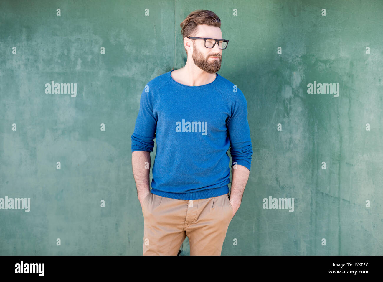 Portrait of a man on the green background Stock Photo - Alamy