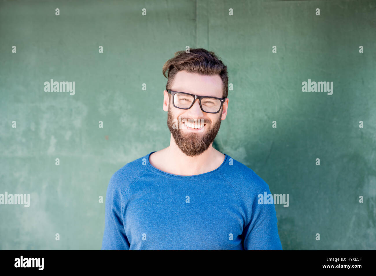 Portrait of a man on the green background Stock Photo - Alamy