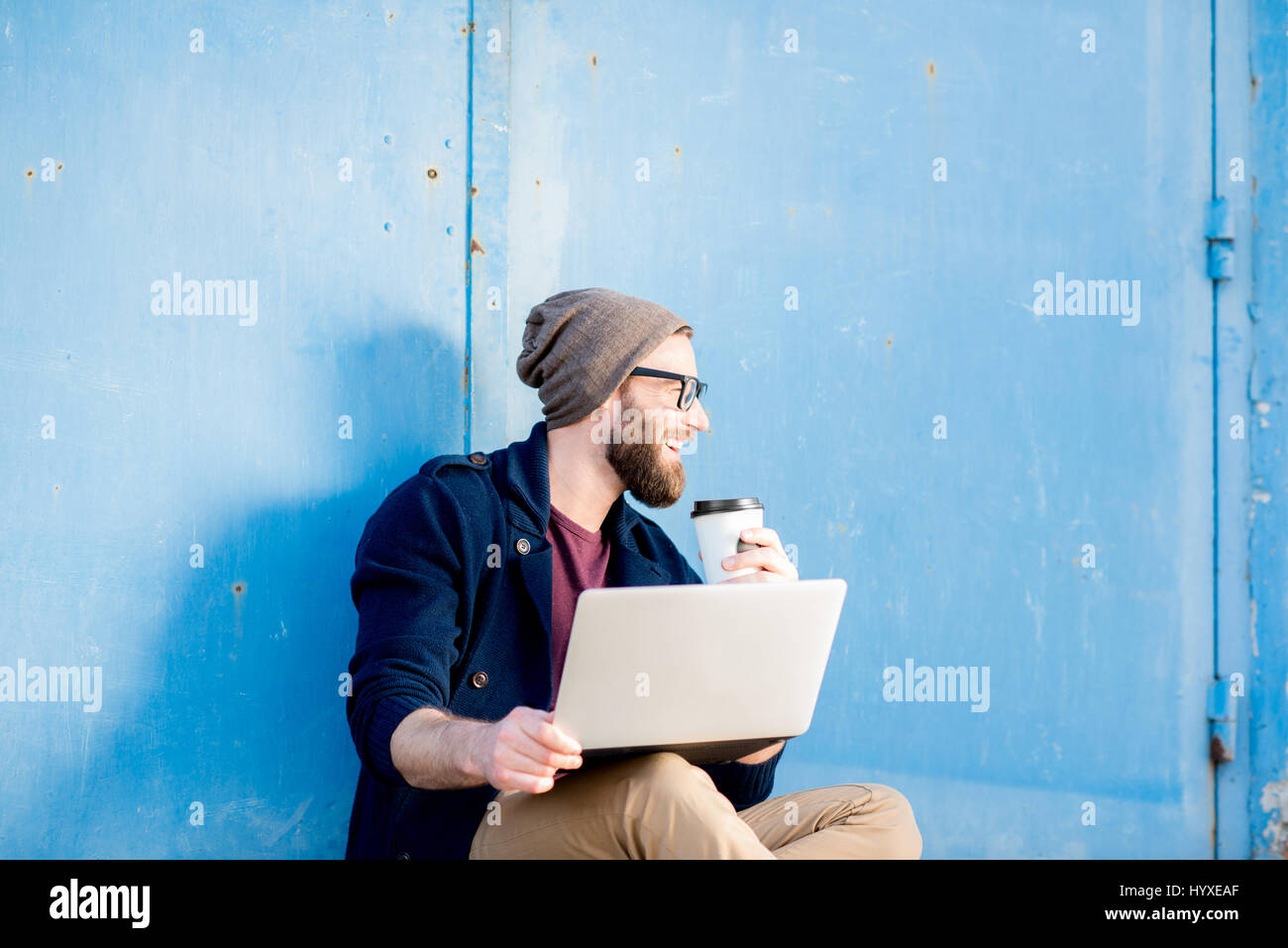 Man with laptop outdoors Stock Photo - Alamy