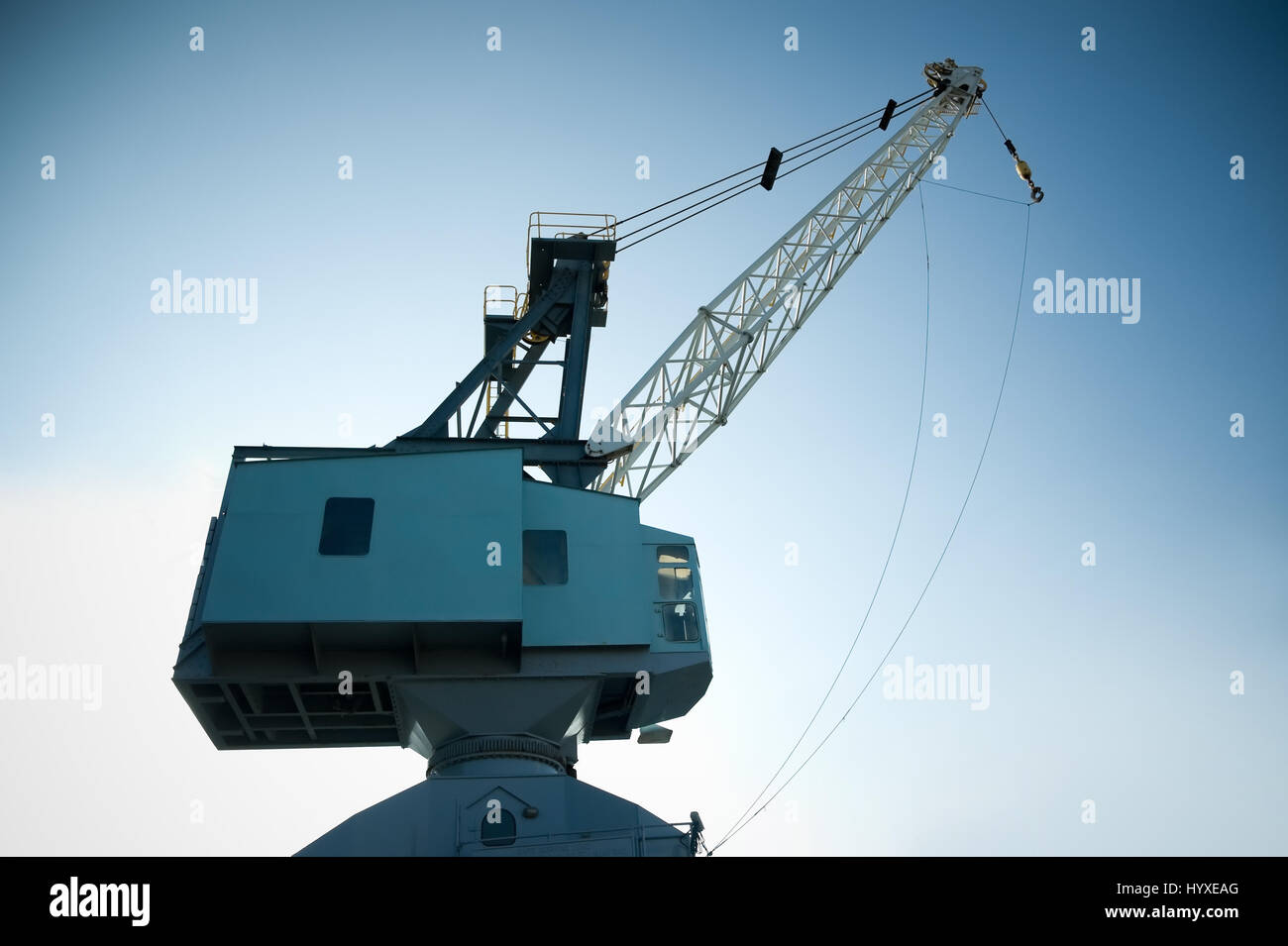 dockyard cargo crane against a gradient blue sky Stock Photo - Alamy