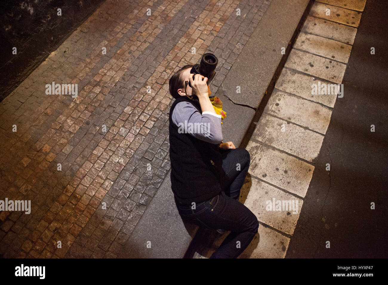 A photographer lays on the ground for a different perspective to take a ...