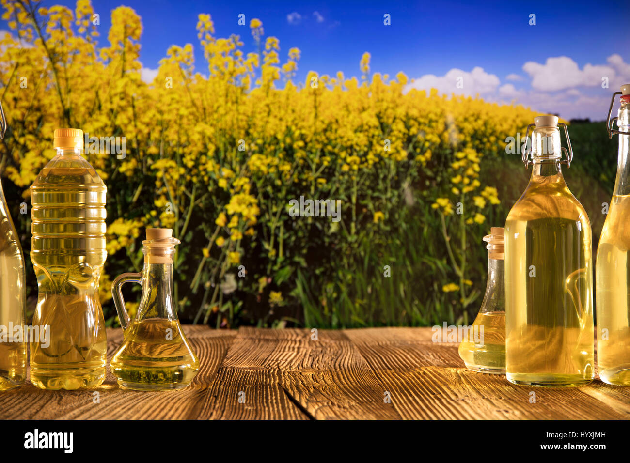 Rapeseed oil concept. Rapeseed oil on rapeseed field background ...