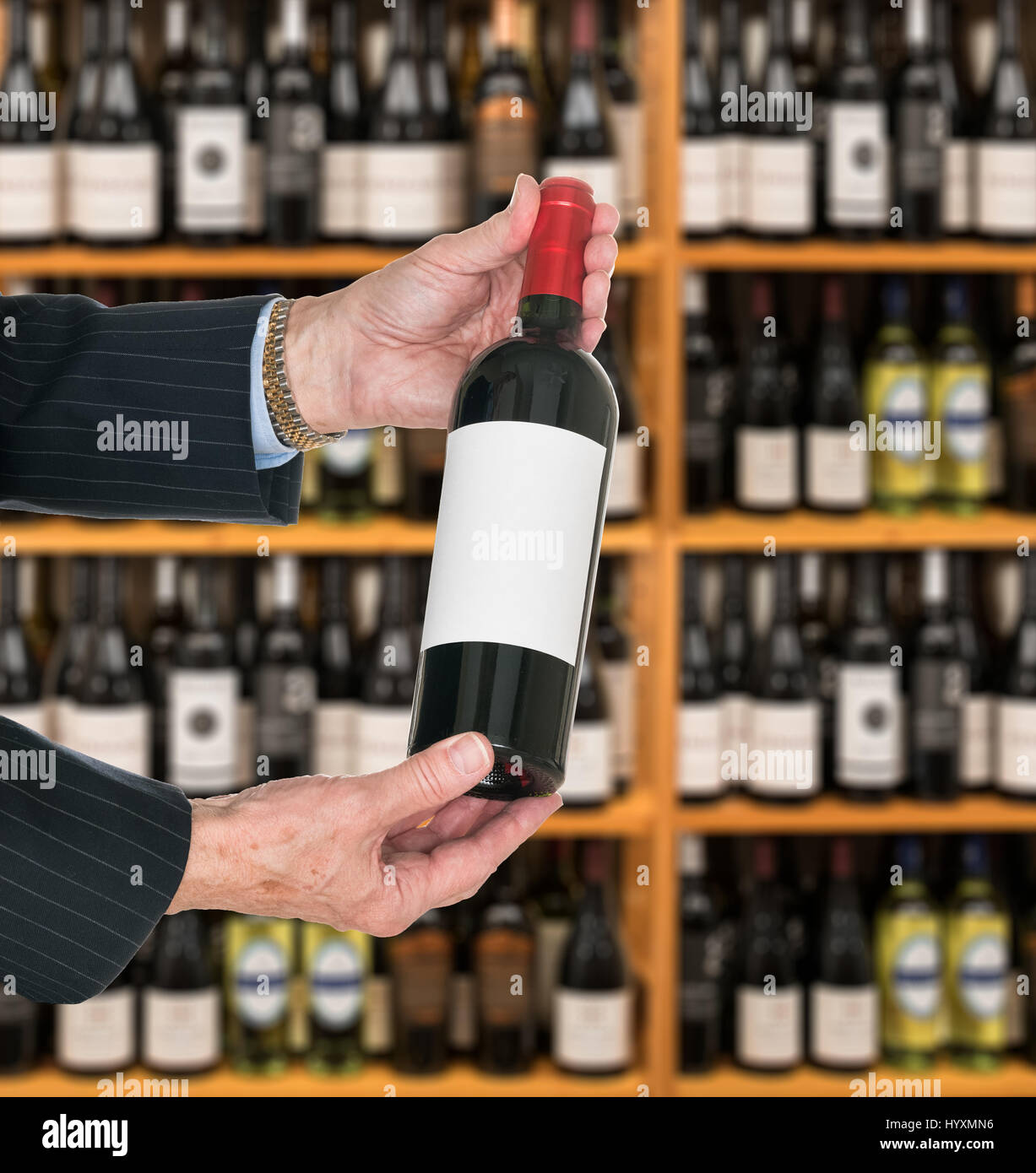 Sommelier offering bottle of red wine to customer Stock Photo - Alamy