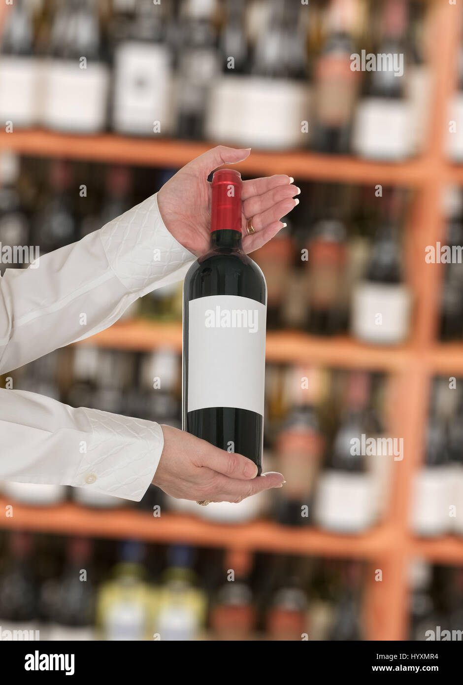 Sommelier offering bottle of red wine to customer Stock Photo - Alamy