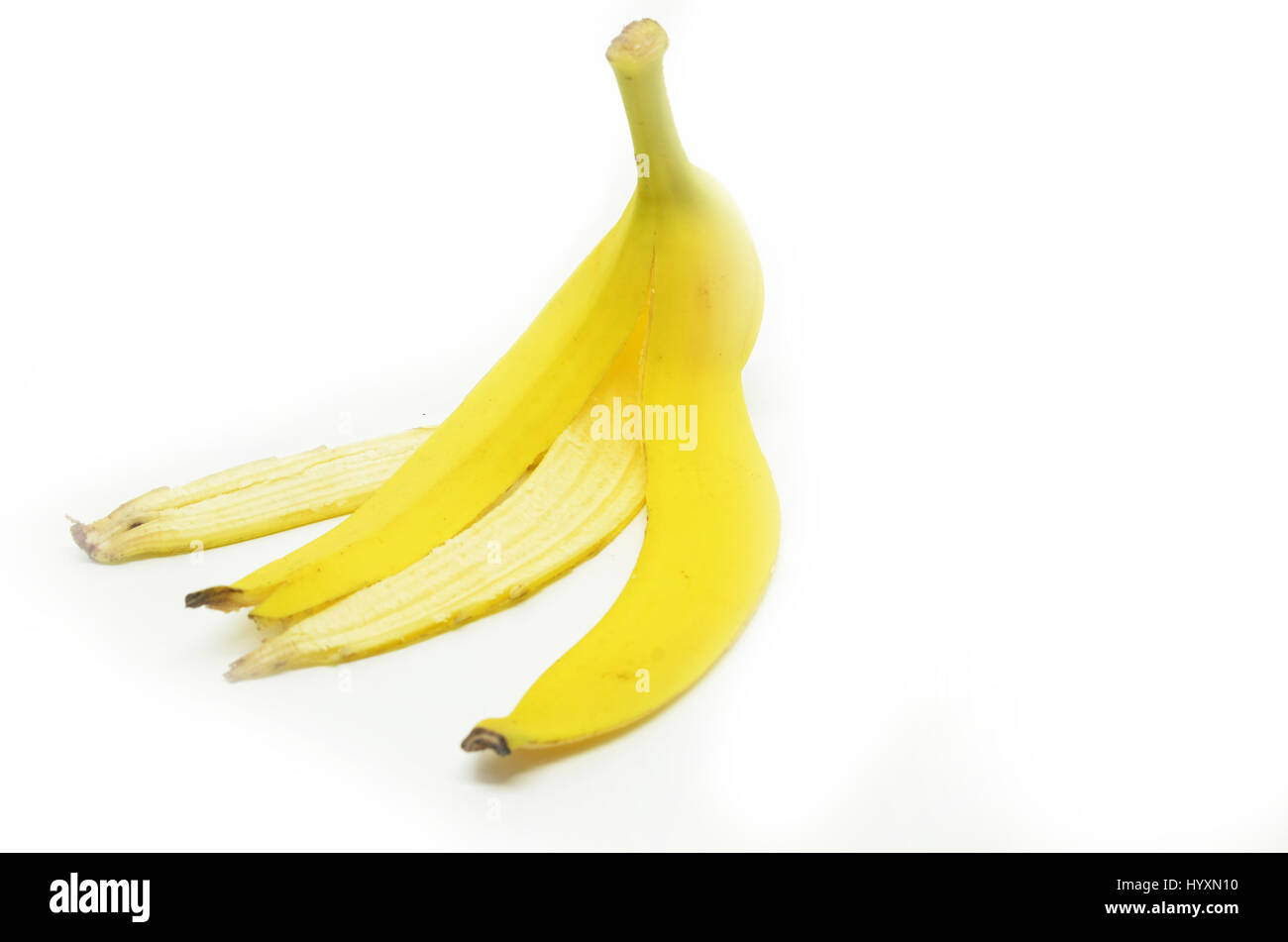 Peeled banana skin isoated on white background Stock Photo - Alamy