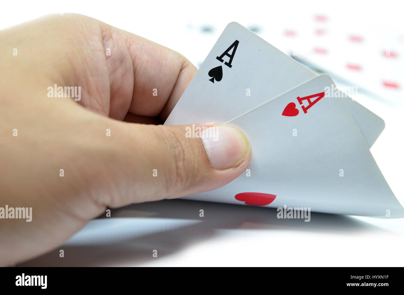 Playing cards in hand isolated on white background Stock Photo - Alamy