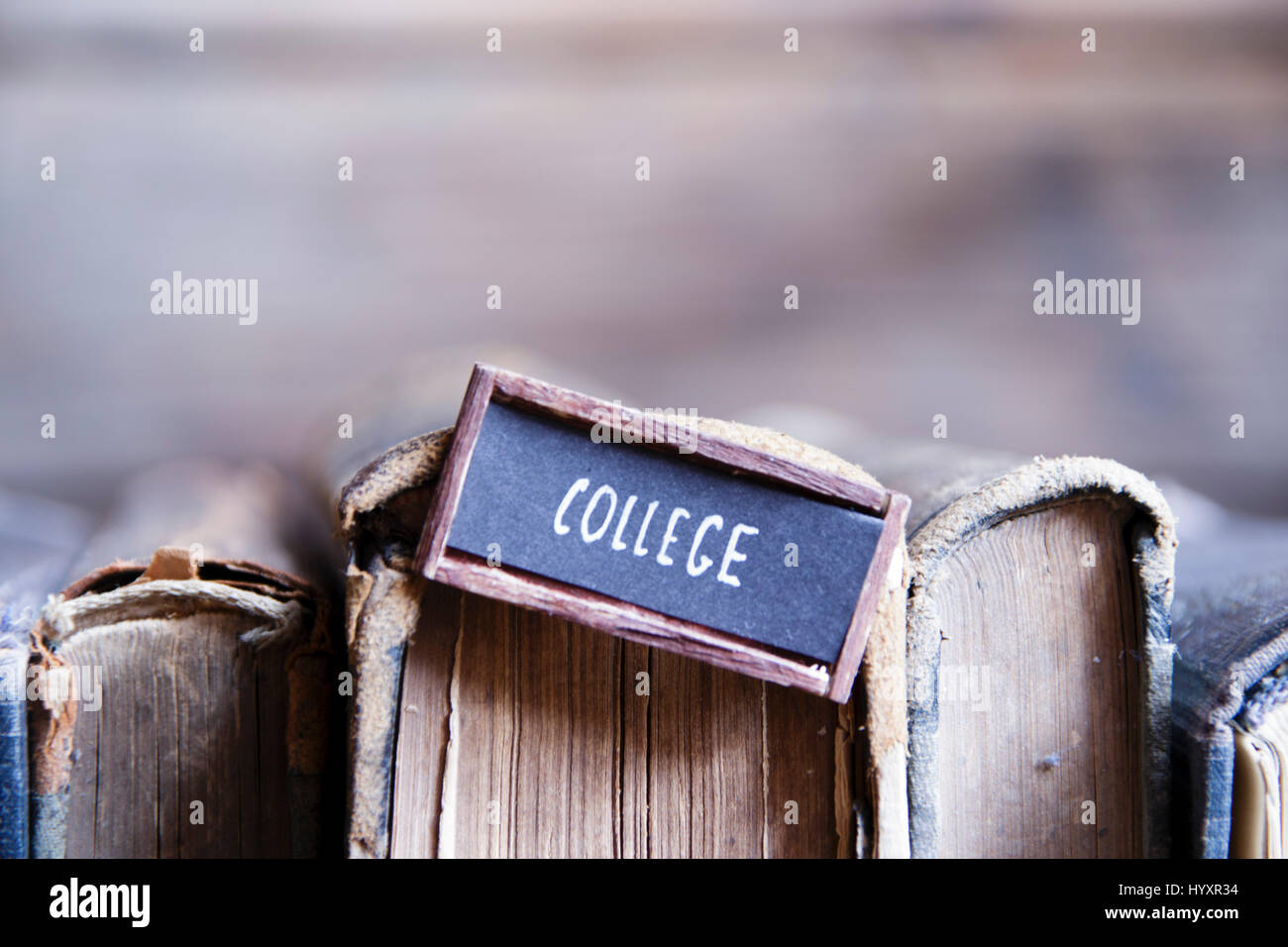 College tag and vintage books on a bookshelf Stock Photo - Alamy