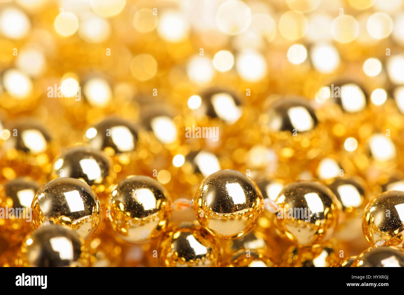 Many bright golden balls macro Stock Photo - Alamy