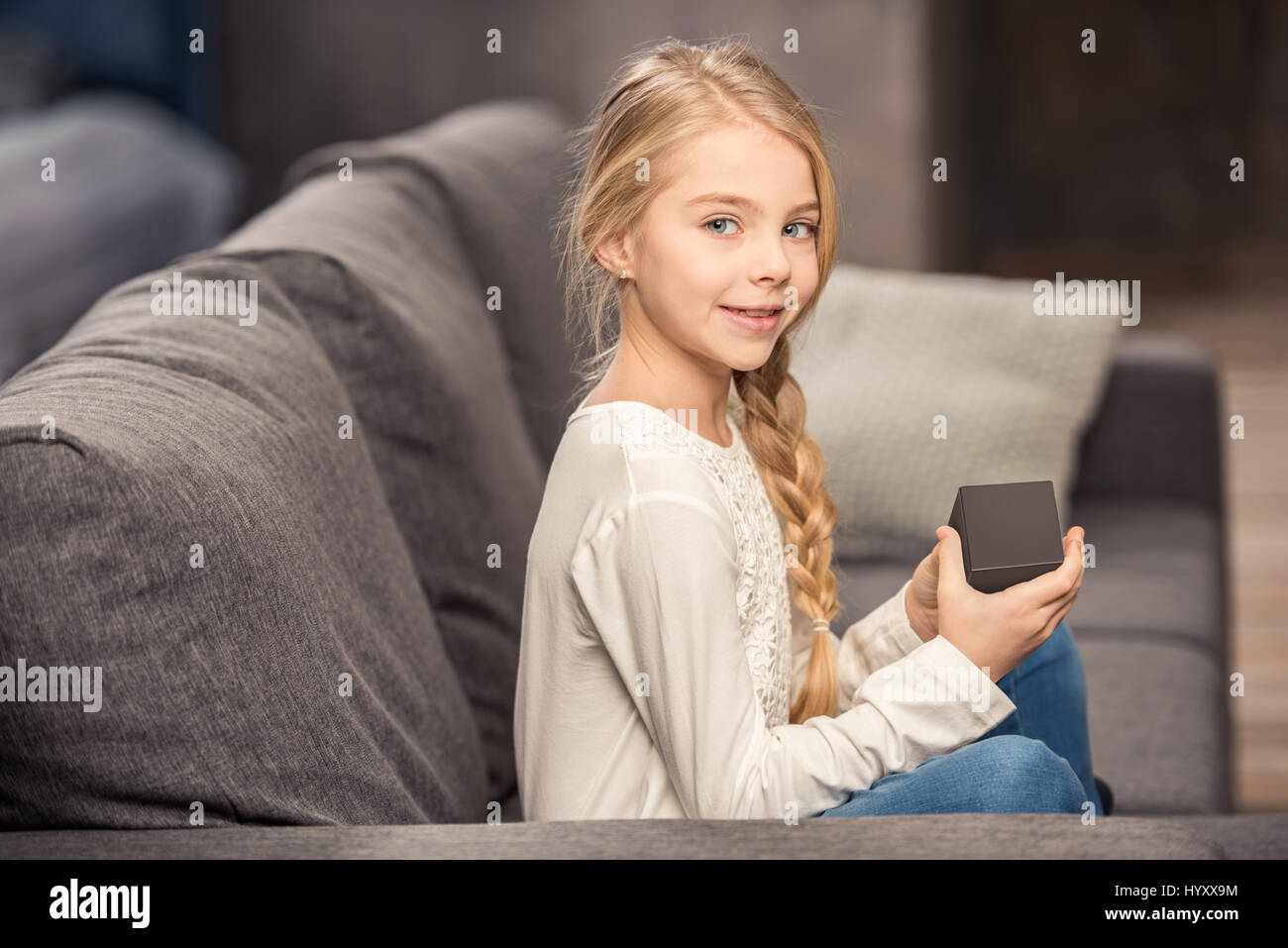 Cute little girl playing with rubik's cube and smiling at camera Stock ...