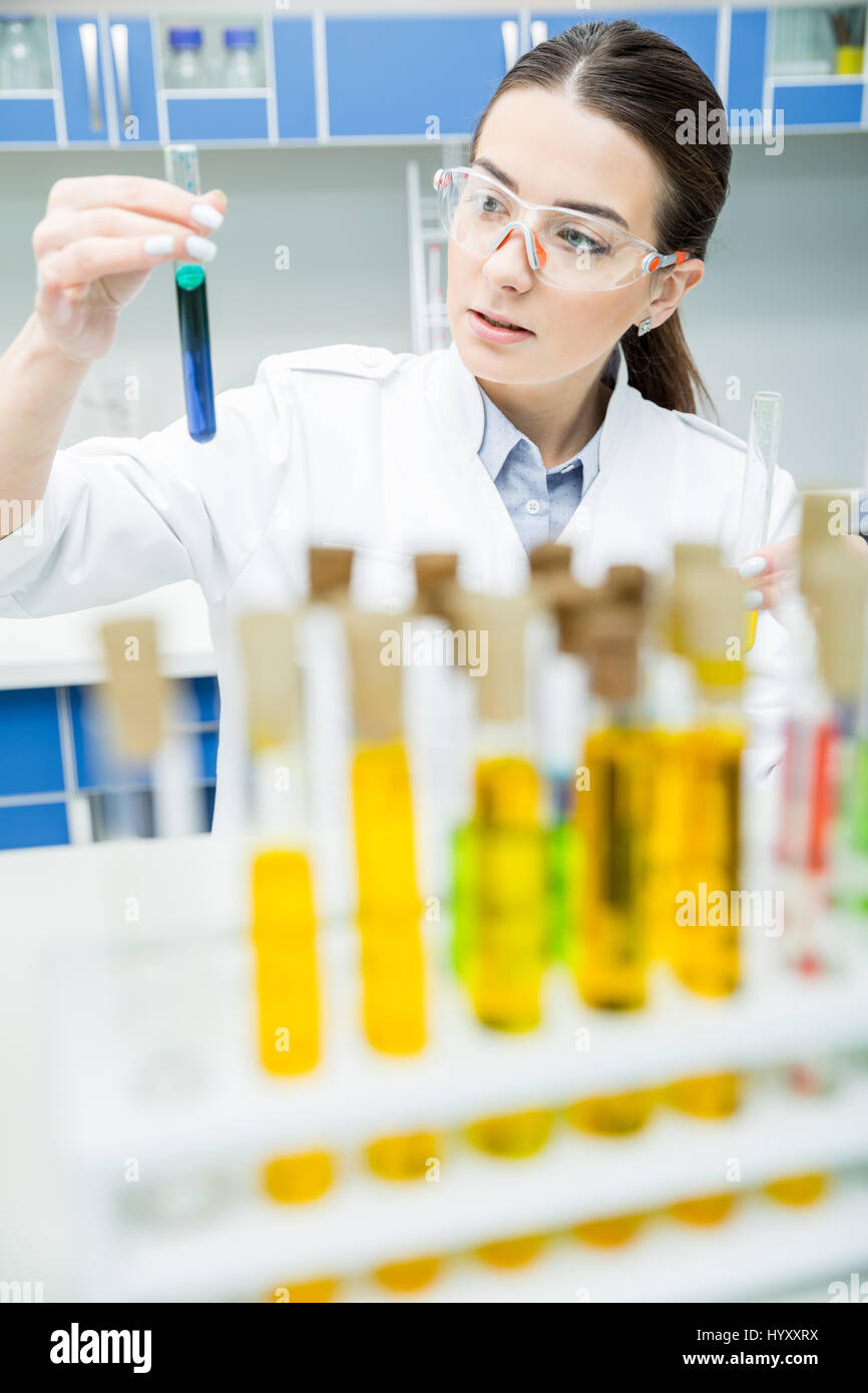 Scientist examining test tube in lab hi-res stock photography and ...