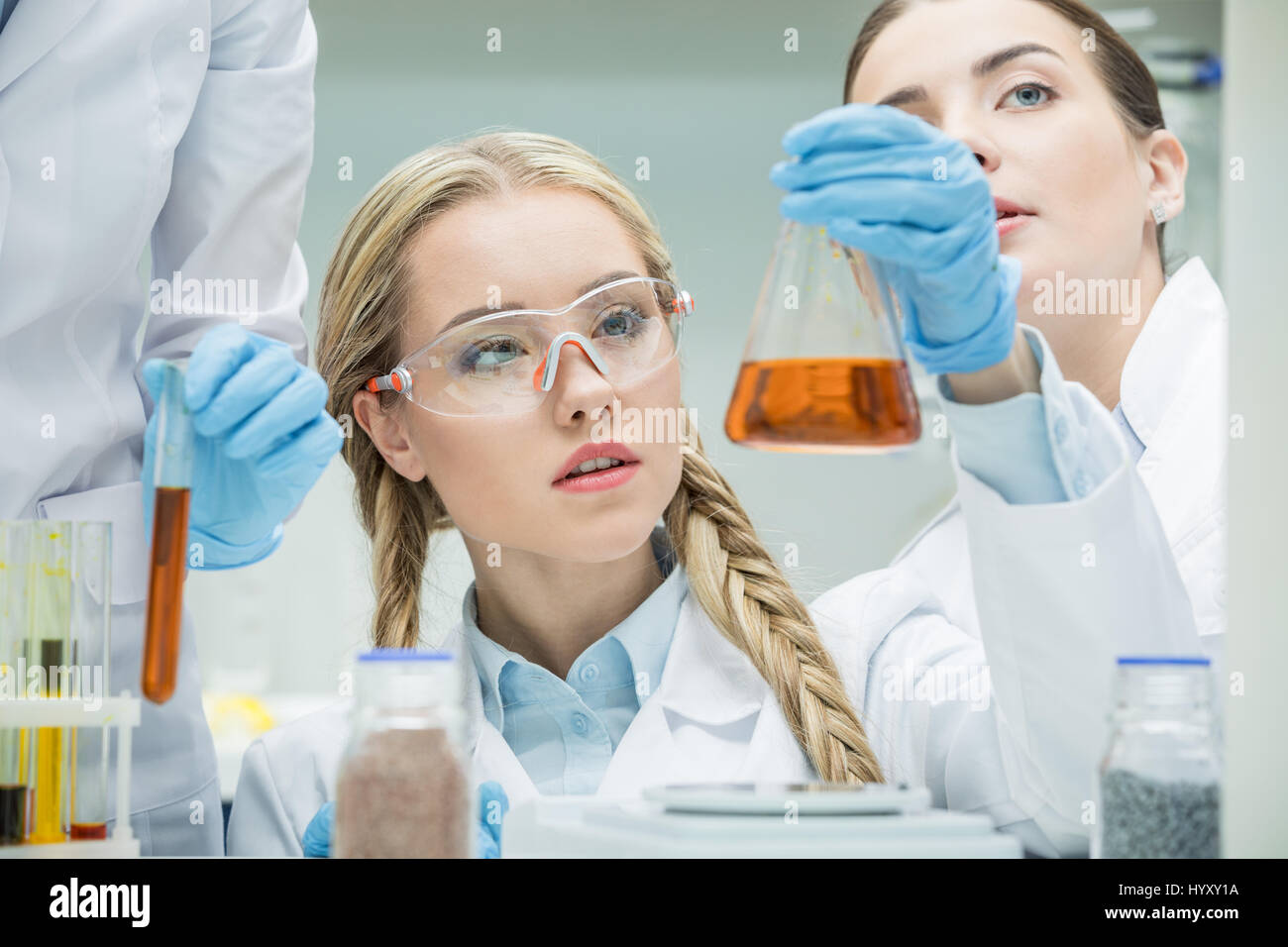 Young female scientist examining chemical sample in laboratory Stock ...