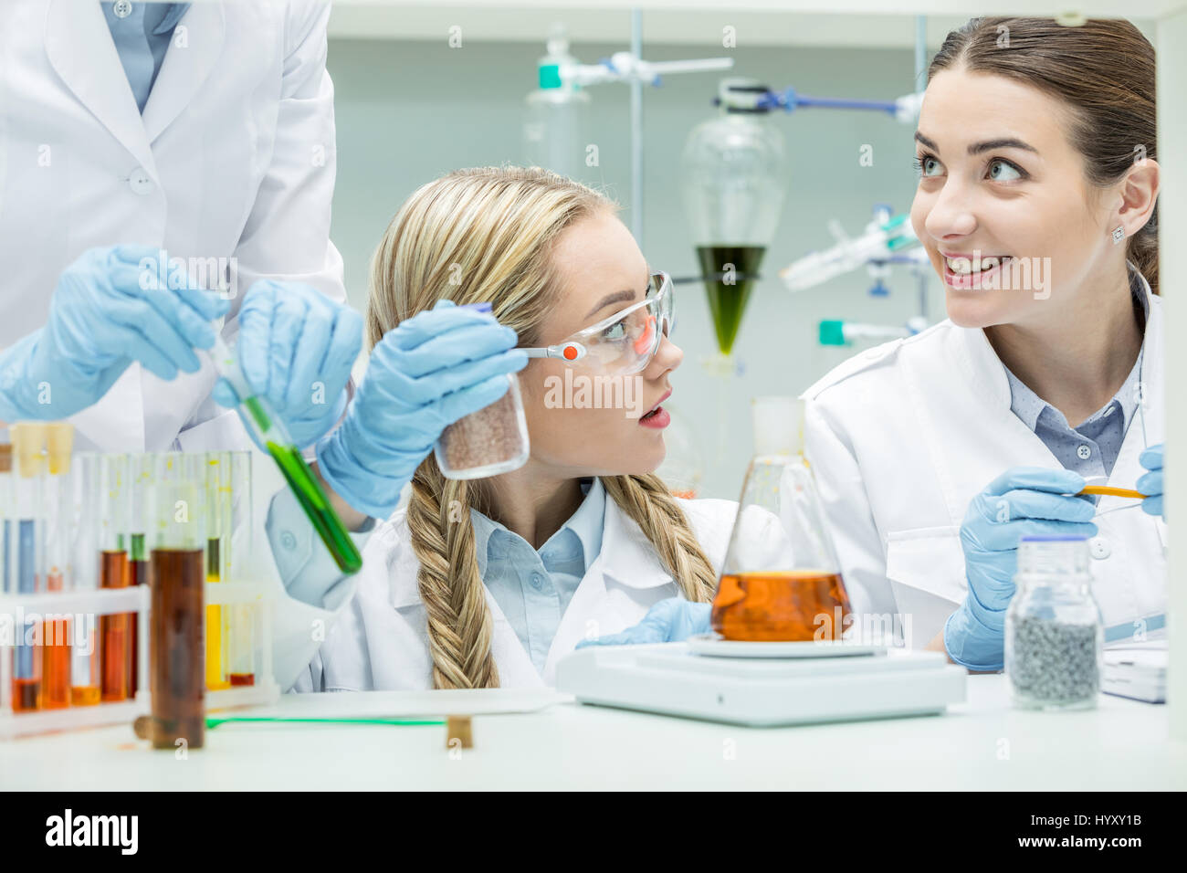 Young female scientists making experiment in chemical laboratory Stock ...