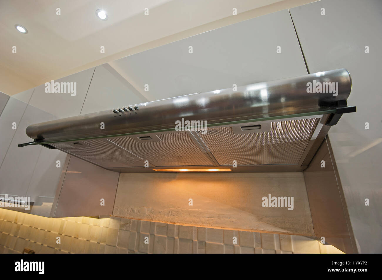 Closeup detail of buttons on metal cooker hood extractor fan with ...